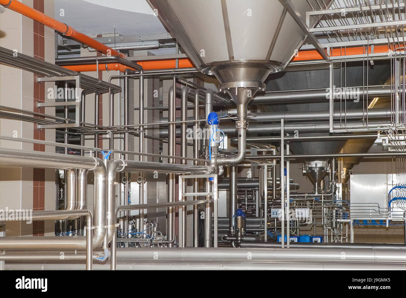 Brewery. Modern beer plant with brewering kettles, tubes and tanks made ...