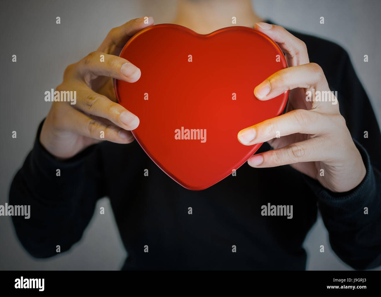 red heart shape hand holding Stock Photo - Alamy
