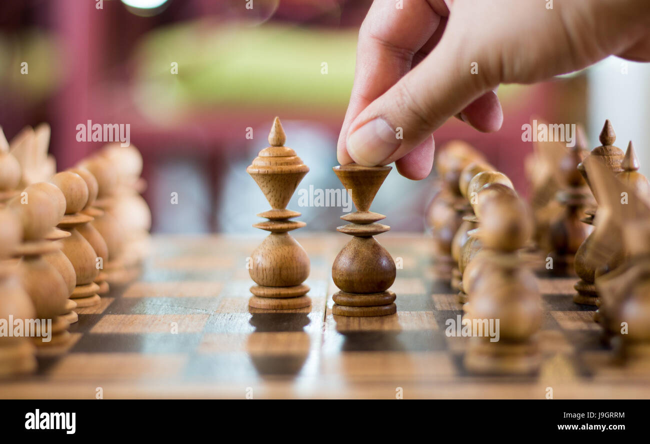 close up hand moving king to figthing inchess game Stock Photo - Alamy