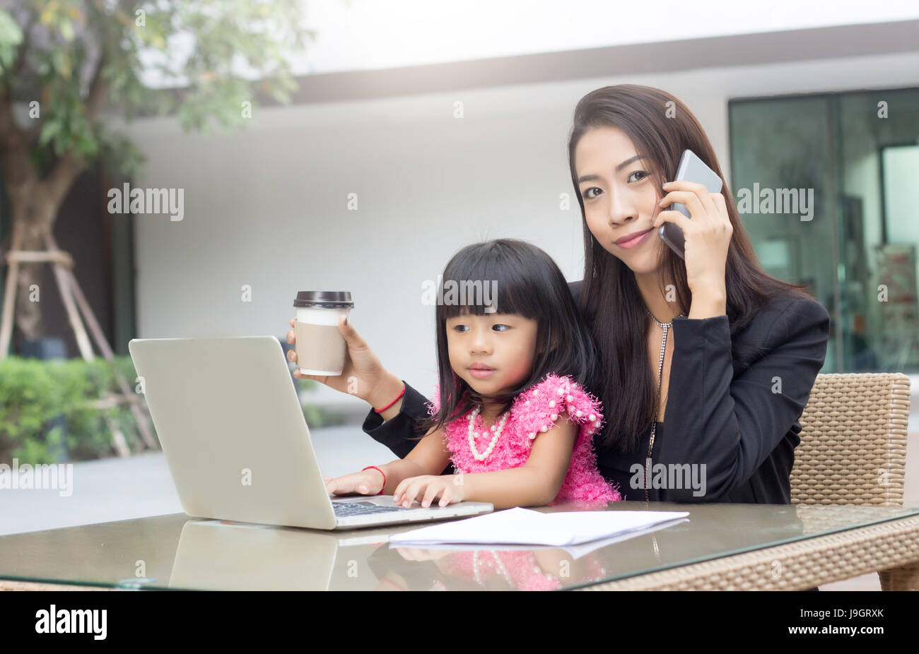 businesswoman work with her daughter laptop Stock Photo - Alamy