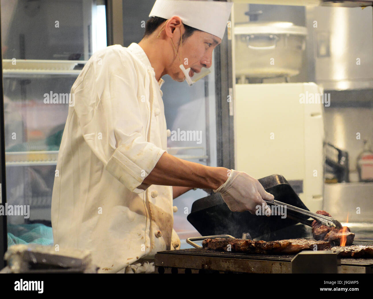 A Japanese cheff grilling steaks in a local Japanese steakhouse in ...