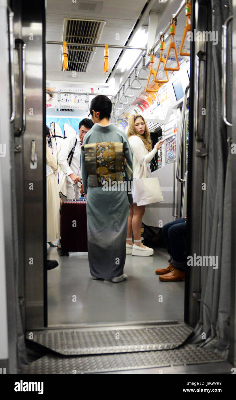 A Japanese woman dressed in Kimono in a Metro / Subway train in Tokyo ...