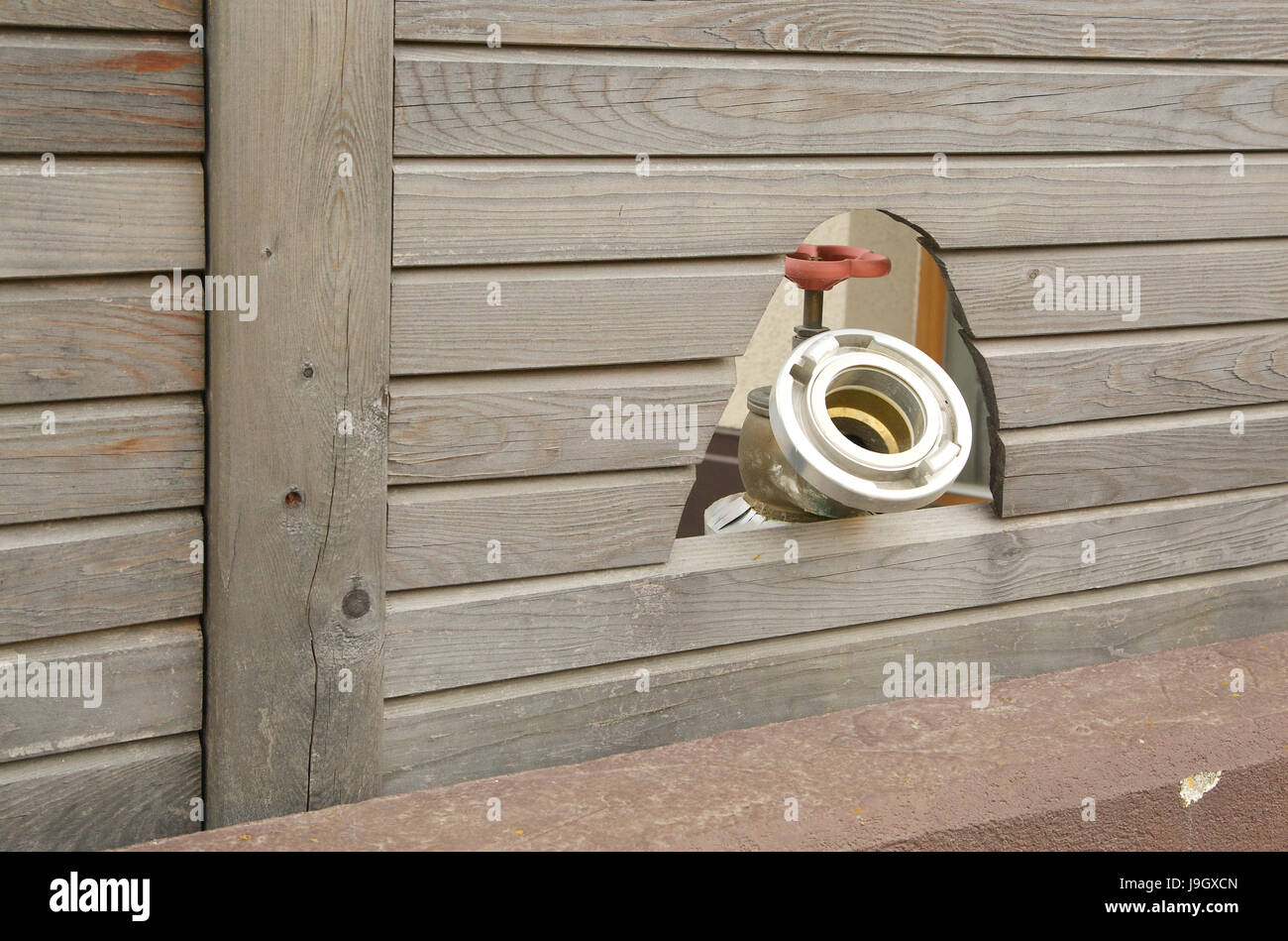One-way fire hydrant valve in the wooden fence Stock Photo - Alamy