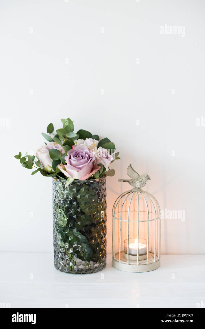 Pastel purple, mauve color fresh summer roses in vase with white wall ...