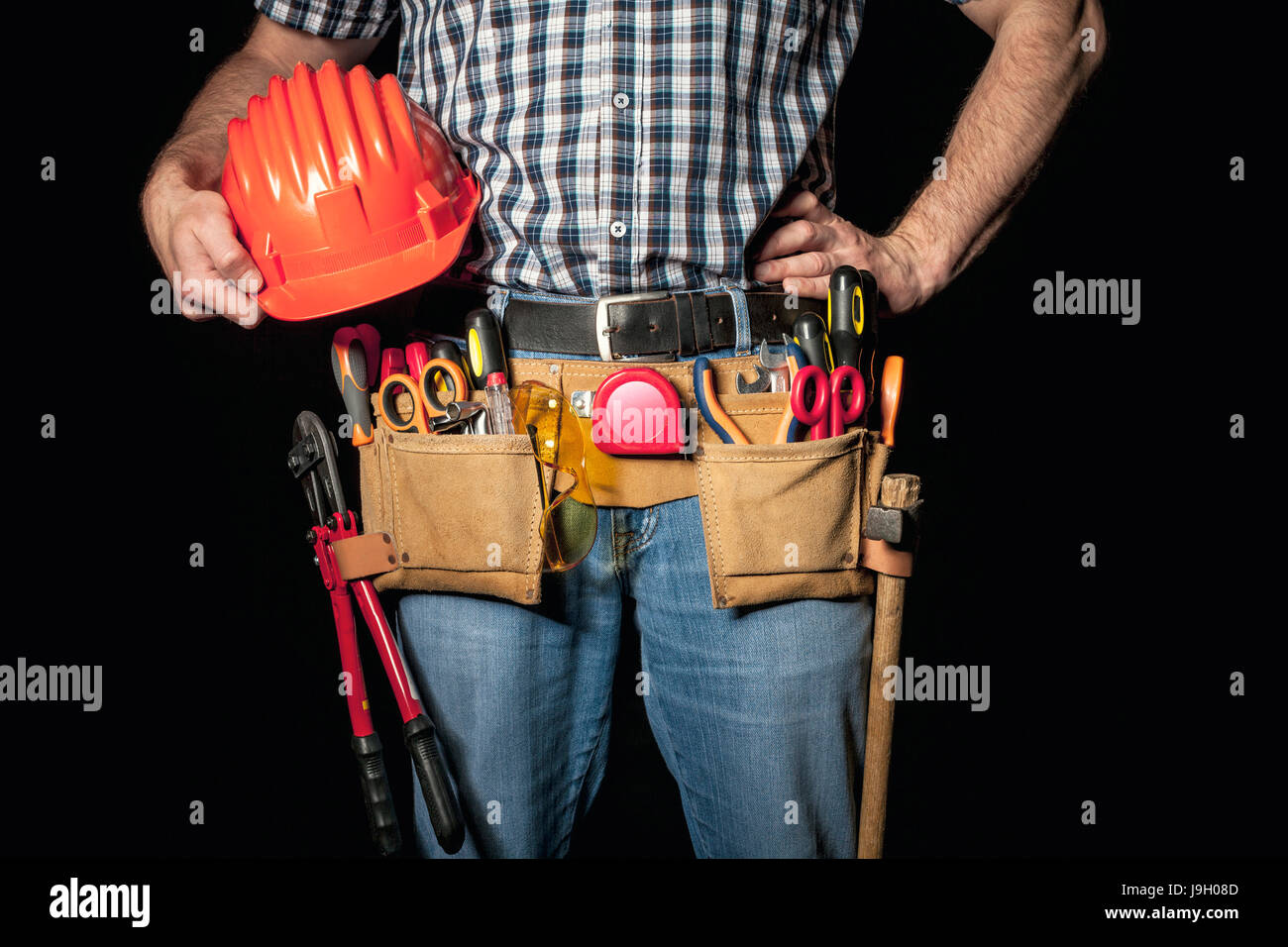 detail of handyman with leather toolsbelt and tools on dark background ...