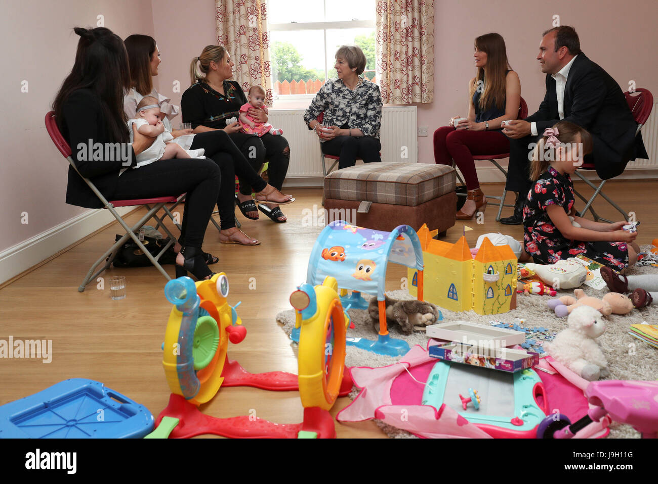Prime Minister Theresa May meets women and children during a visit to ...