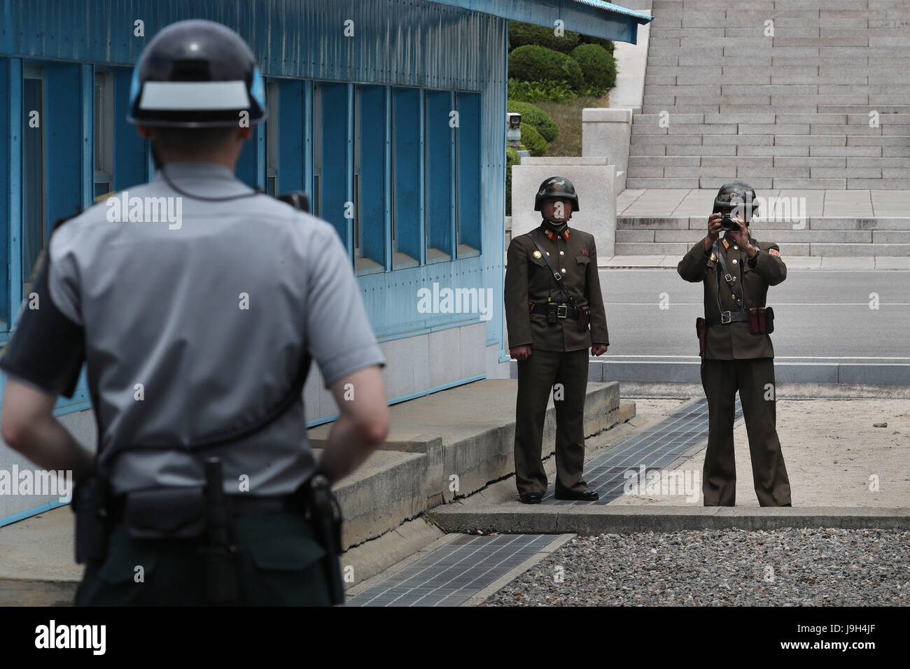 N. Korean soldiers at Panmunjom A North Korean soldier takes a photo of ...