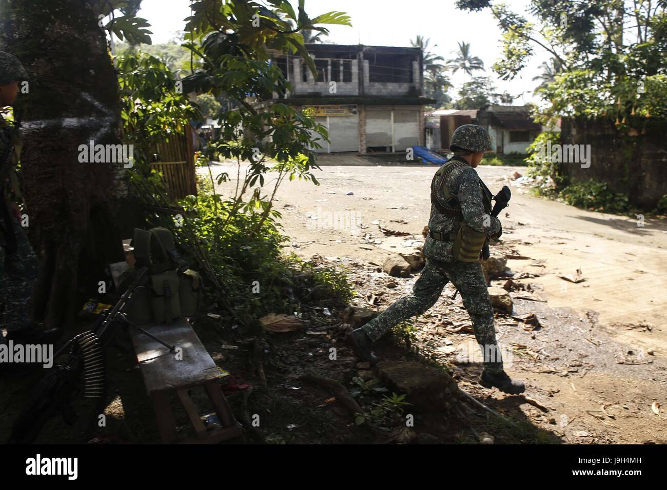 A philippine soldier secures a stronghold position in the village of ...