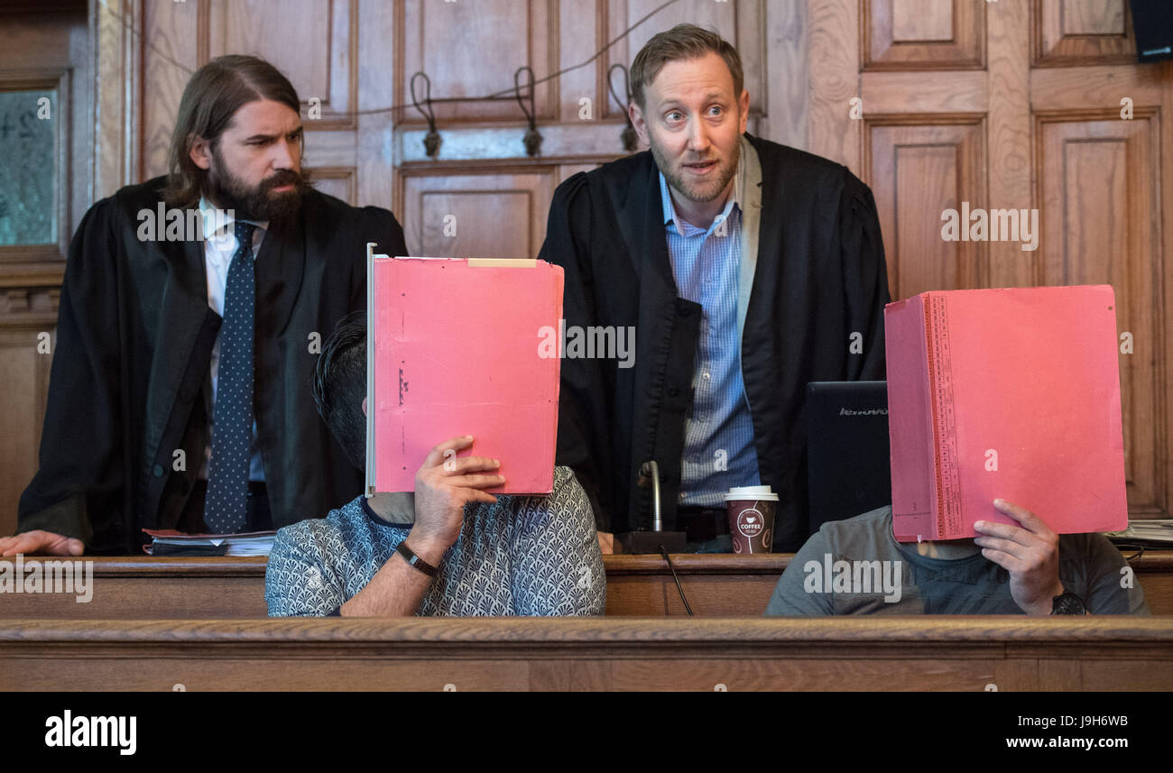 The two defendants Ahmet K. and Hakan C. hide their faces behind ... The two defendants Ahmet K. and Hakan C. hide their faces behind ...