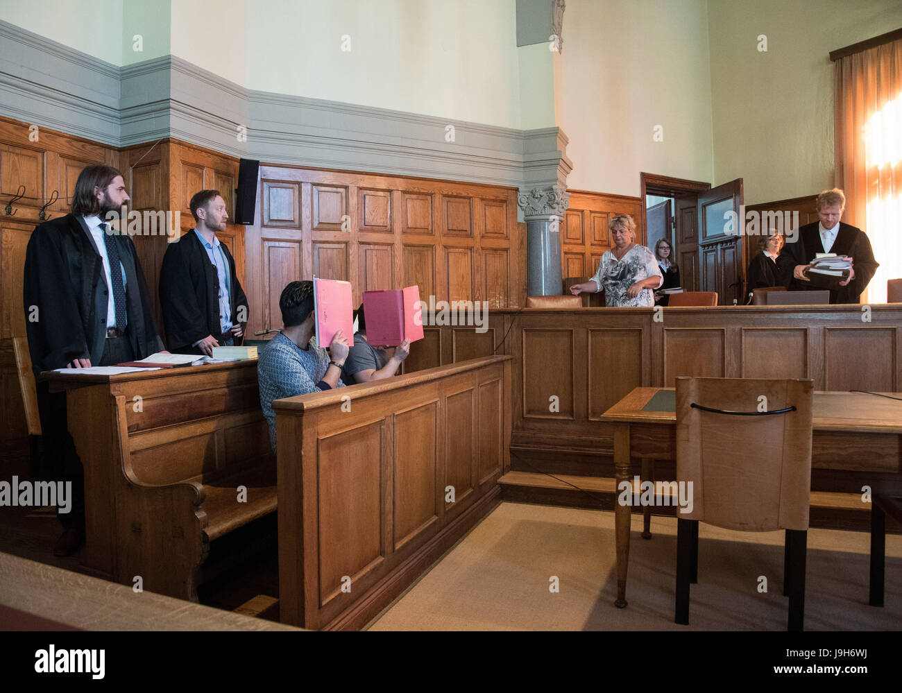 The two defendants Ahmet K. and Hakan C. hide their faces behind ... The two defendants Ahmet K. and Hakan C. hide their faces behind ...
