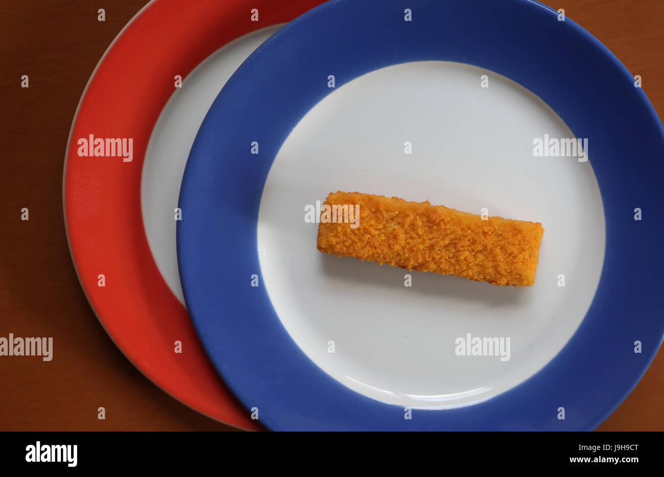 ILLUSTRATION - A raw fish finger seen on a plate with a blue frame ...