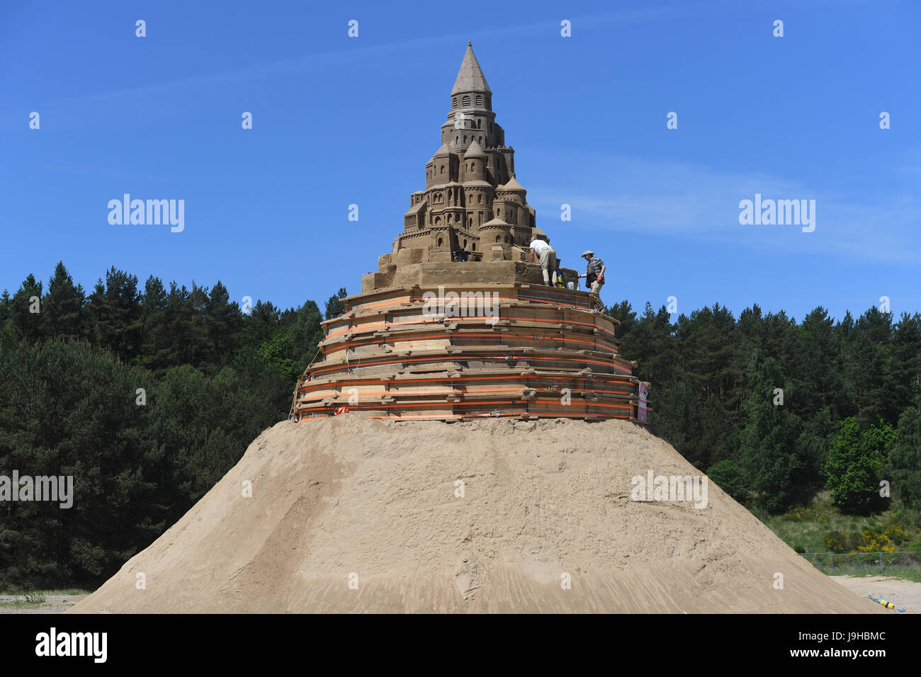 Sculptors work on the sand sculpture 'Biggest Sand Castle in the World ...