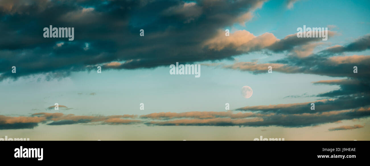 Full Moon At Blue Evening Cloudscape Sky Background Stock Photo - Alamy
