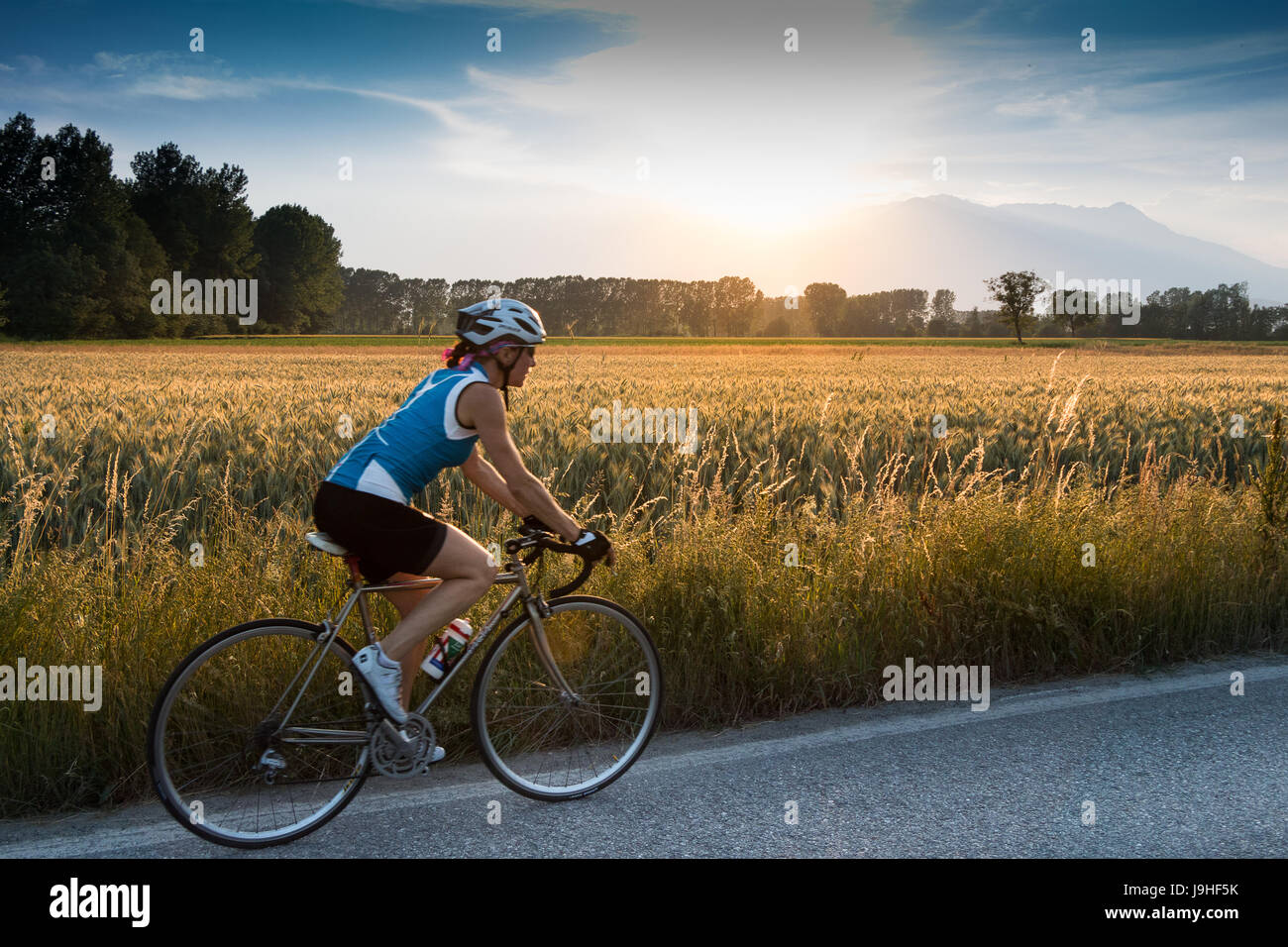A Woman Riding A Bike In The Countryside Stock Photos & A Woman Riding ...