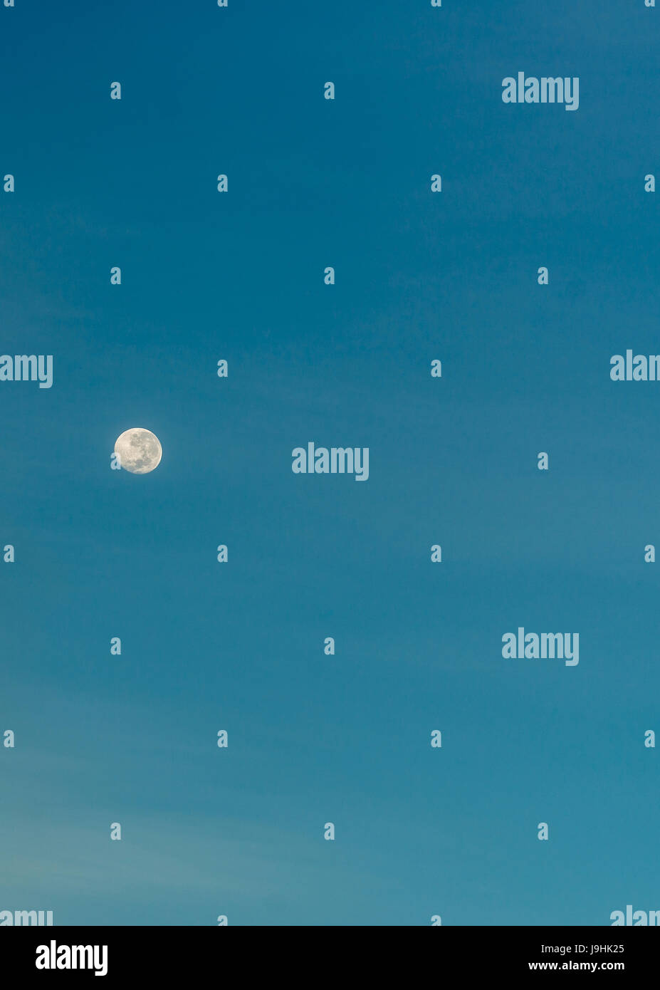 Port Chalmers, New Zealand - March 15, 2017: Full moon in blue sky at ...