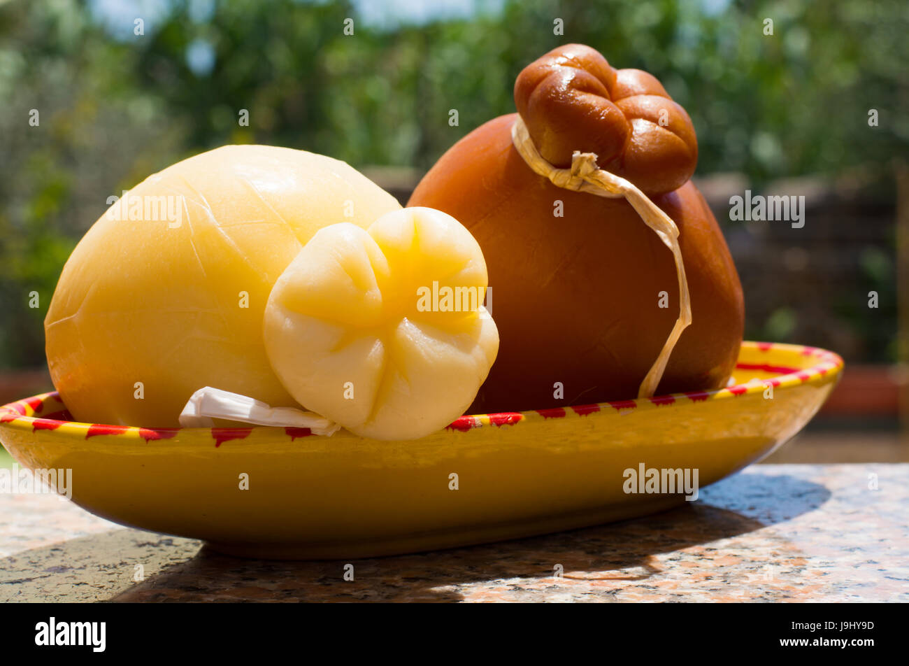 Traditional Italian hard cheese Provolone of Caciocavallo, white and ...