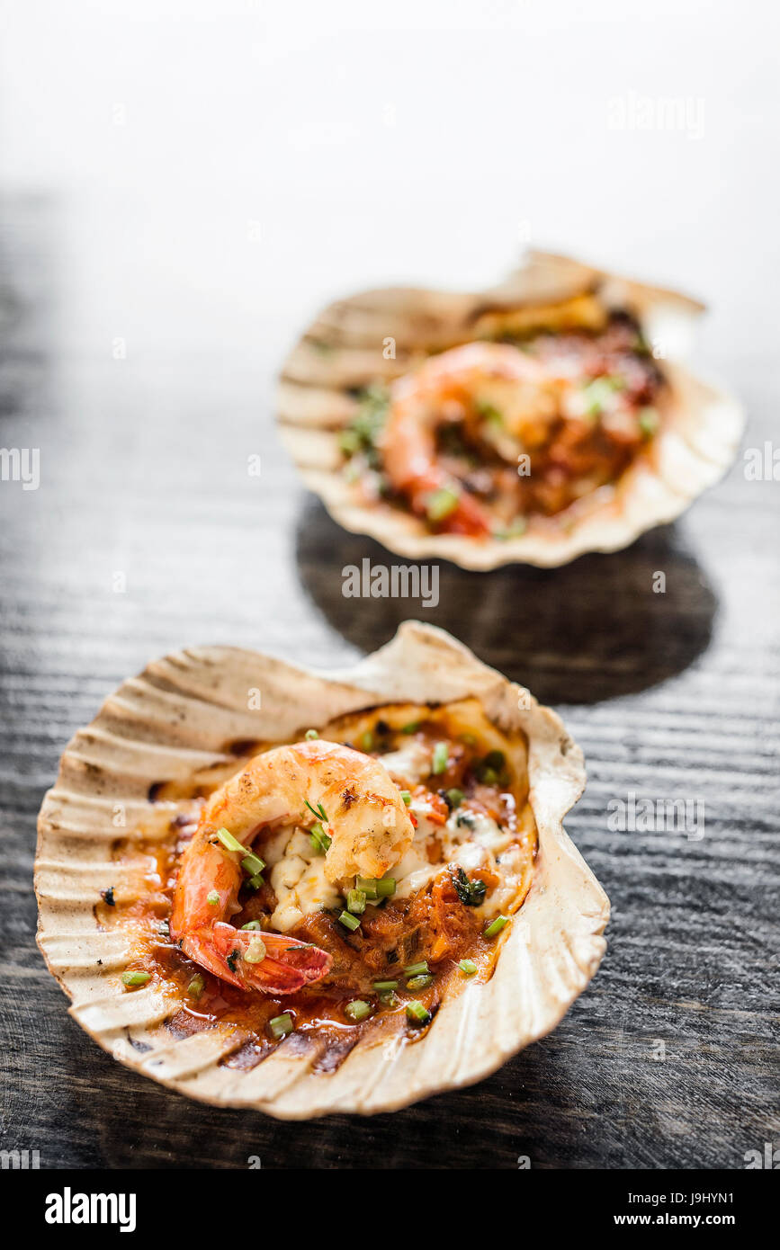 gourmet cuisine baked king prawns in spicy tomato and herb sauce Stock ...