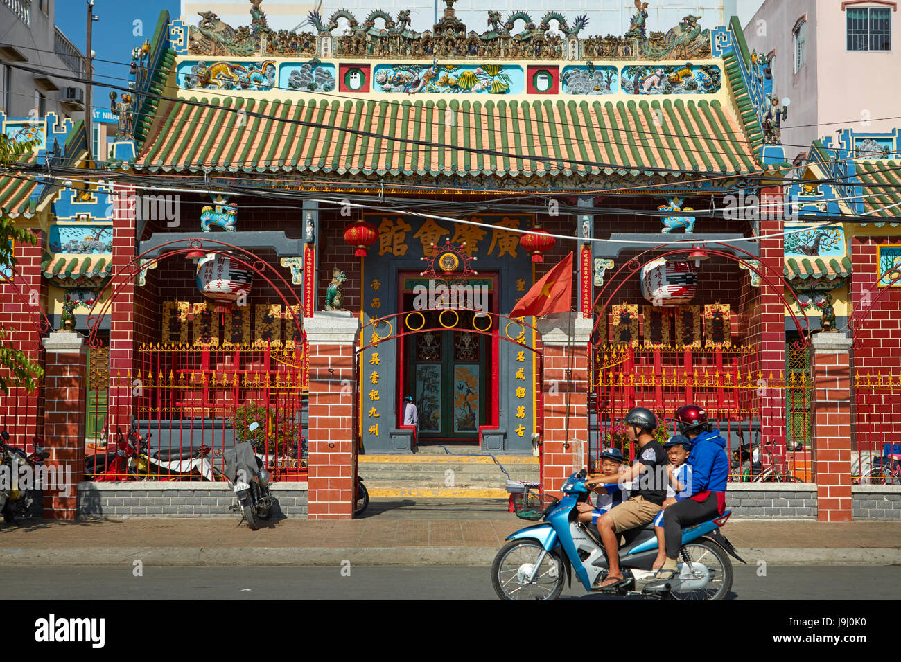 Family of four on a motorcycle going past Ong Pagoda, Can Tho, Mekong ...