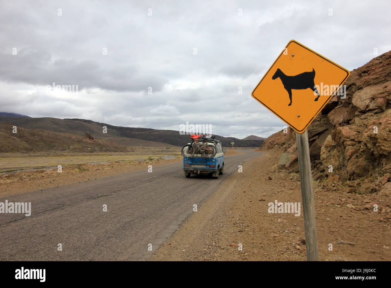 Warning sign for goats on road and vintage van driving, Neuquen ...