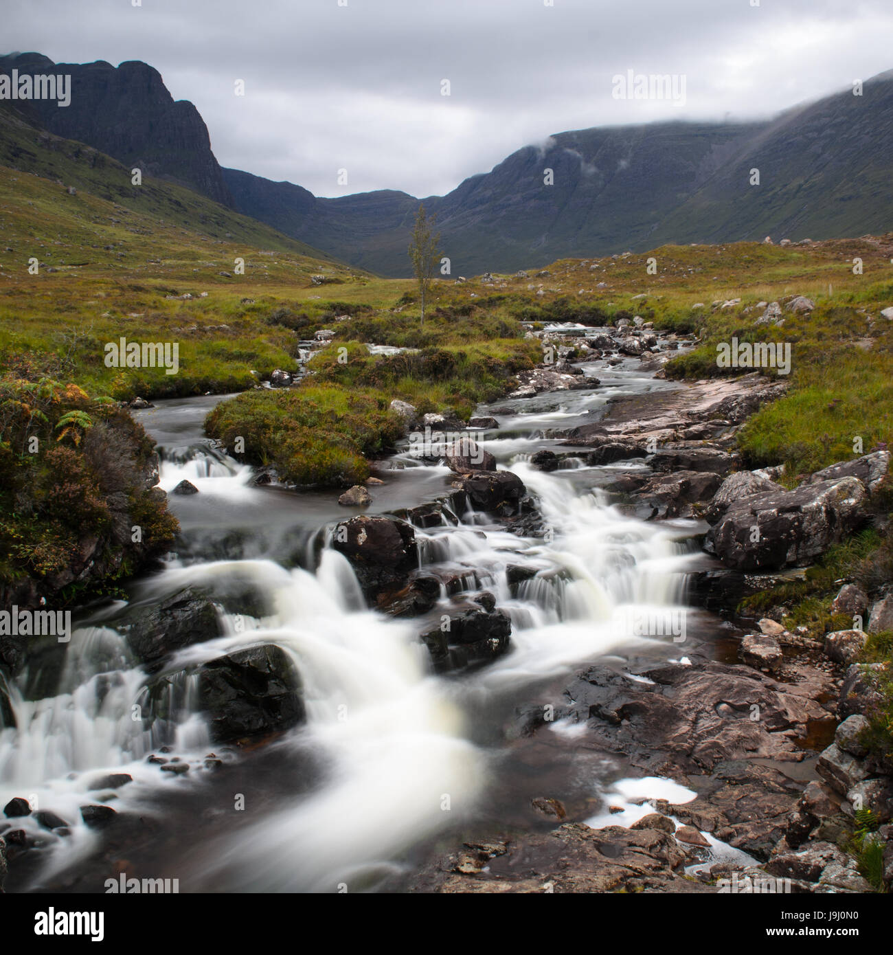 The Russel Burn mountain stream tumbles over rocky waterfalls in a ...