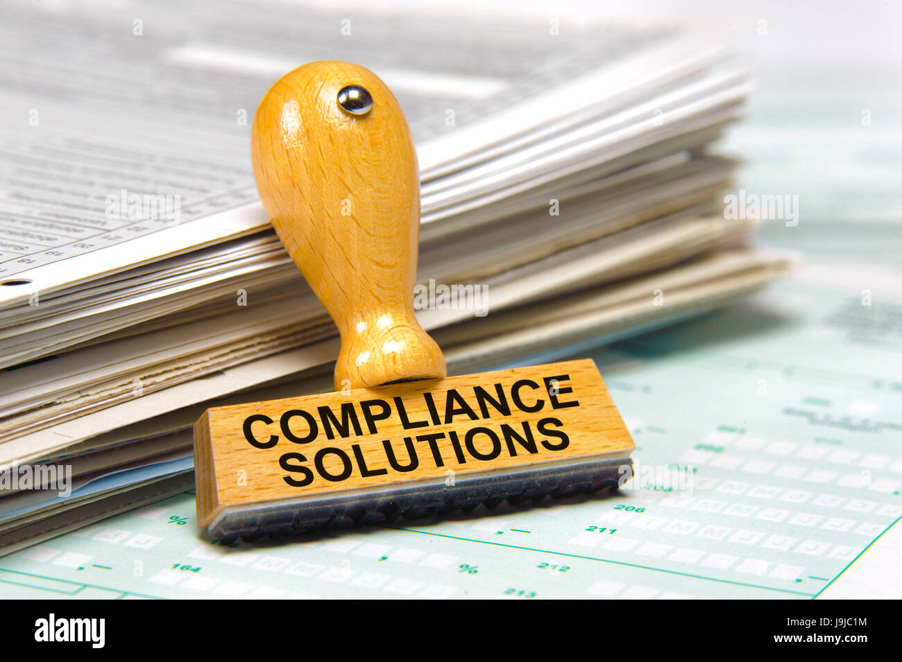 compliance solutions marked on rubber stamp Stock Photo - Alamy