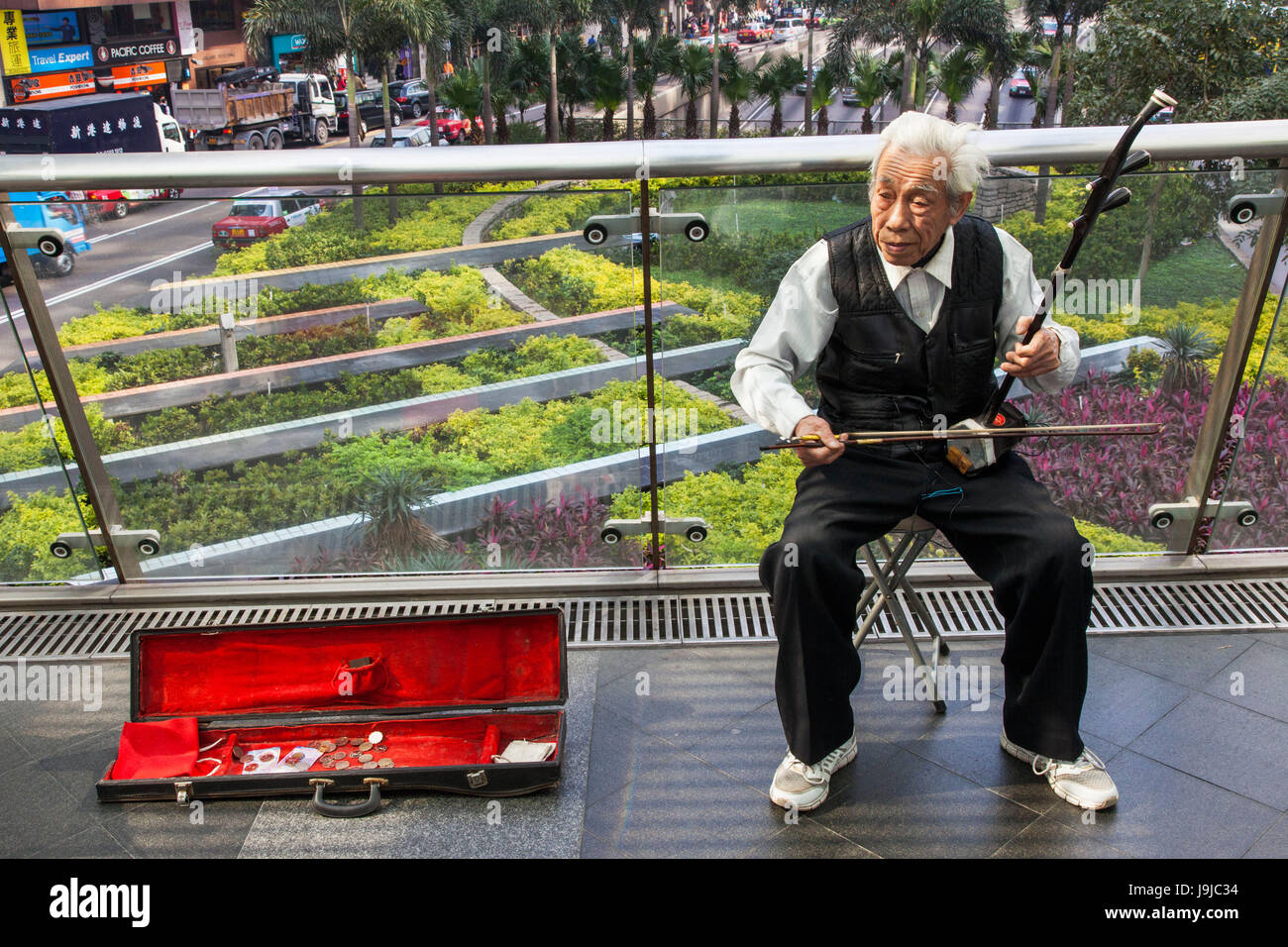 China, Hong Kong, Central, Elderly Busker Playing the Traditional ...