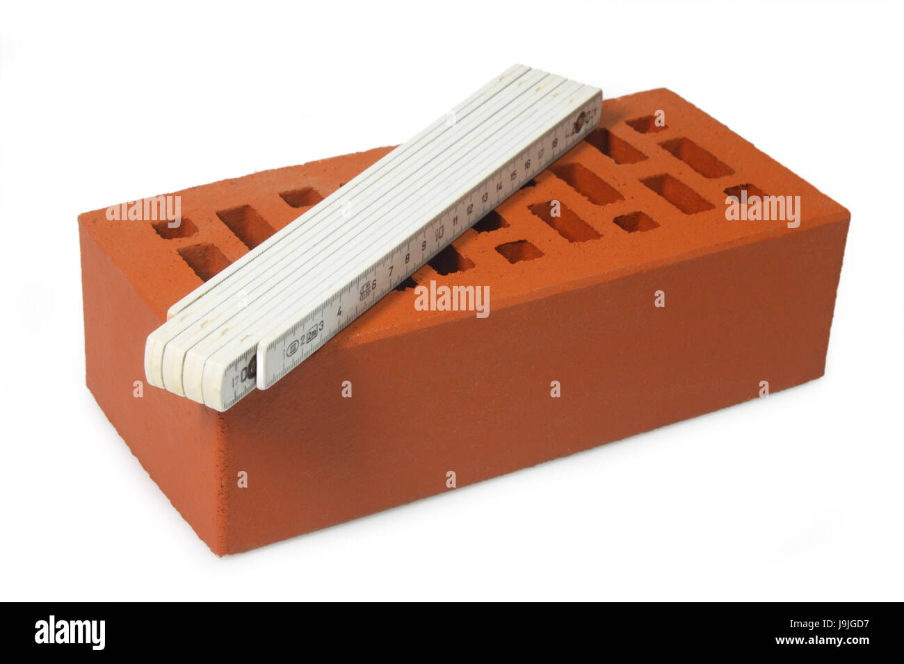 Red brick and folding rule isolated on white background Stock Photo - Alamy