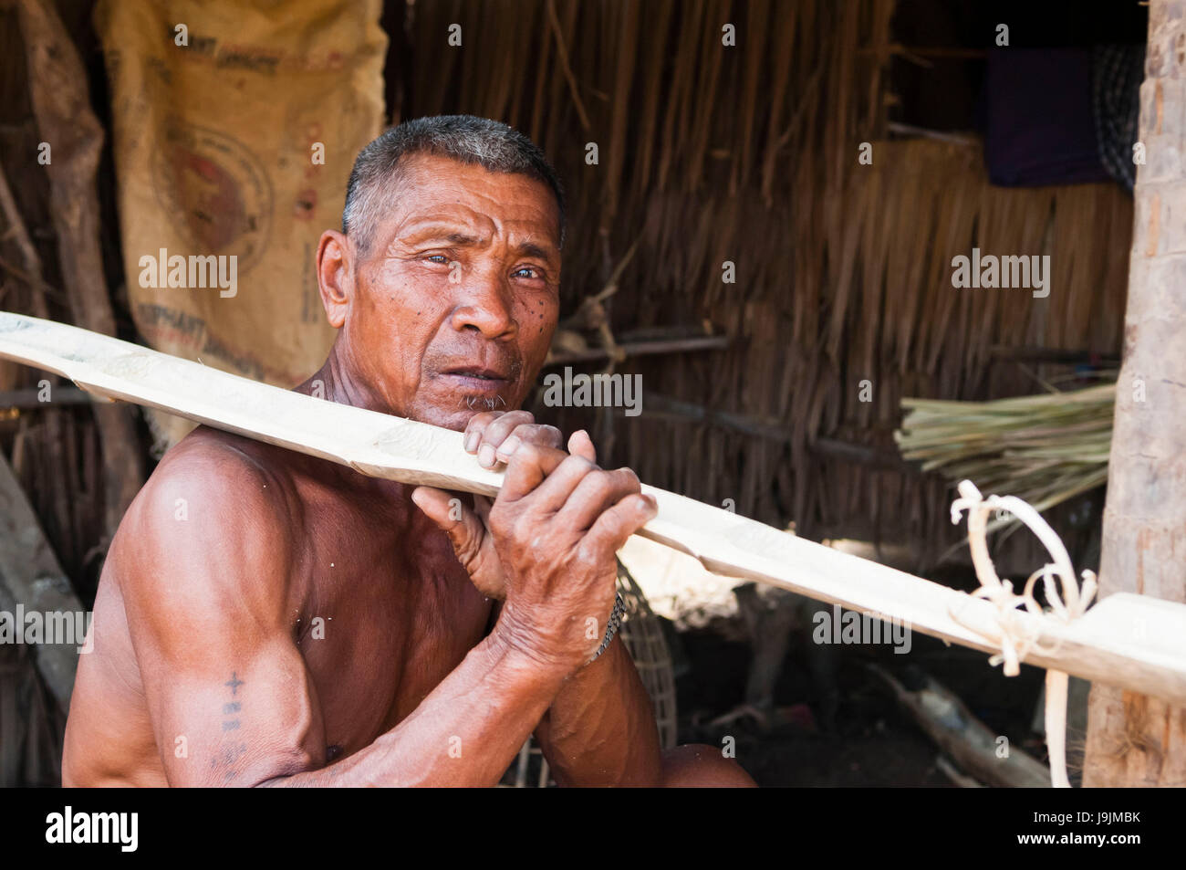 a Burmese works with bamboo Stock Photo - Alamy