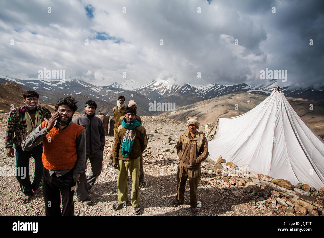 Construction workers waiting by the roadside at high altitude in the ...