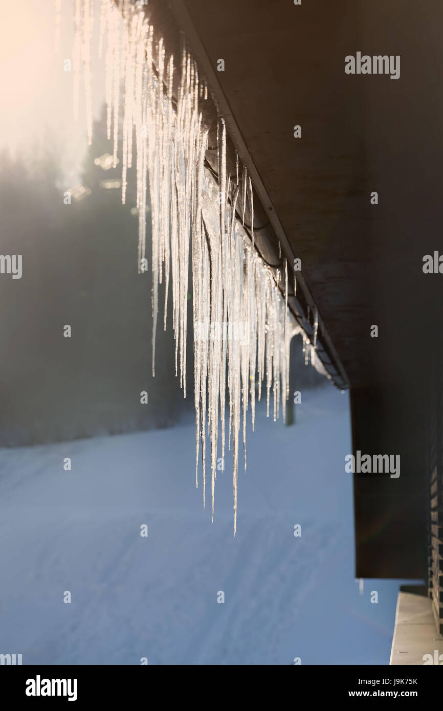 beautiful icicles on the roof of the house on the sunny day Stock Photo ...