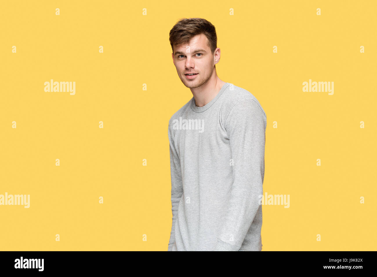 The young man smiling and looking at camera Stock Photo - Alamy