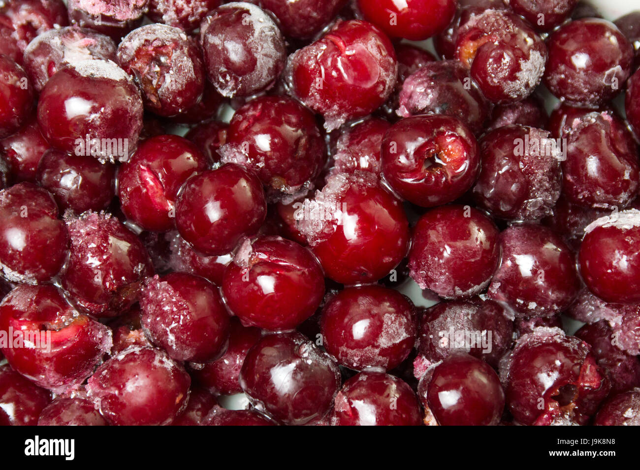 Frozen cherry fruit on a pile background Stock Photo - Alamy