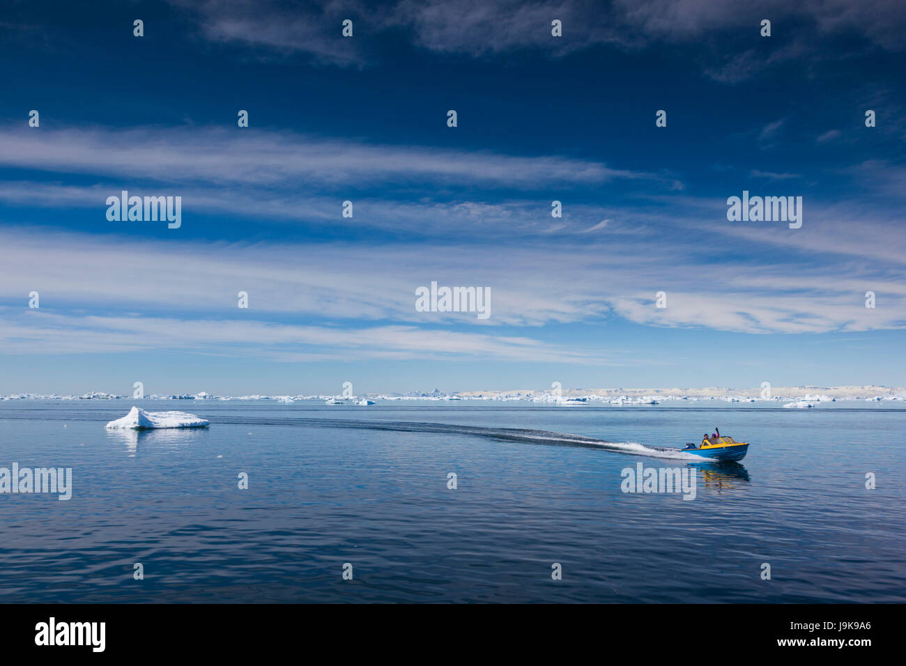 Greenland, Disko Bay, Oqaatsut, floating ice and small boat Stock Photo ...