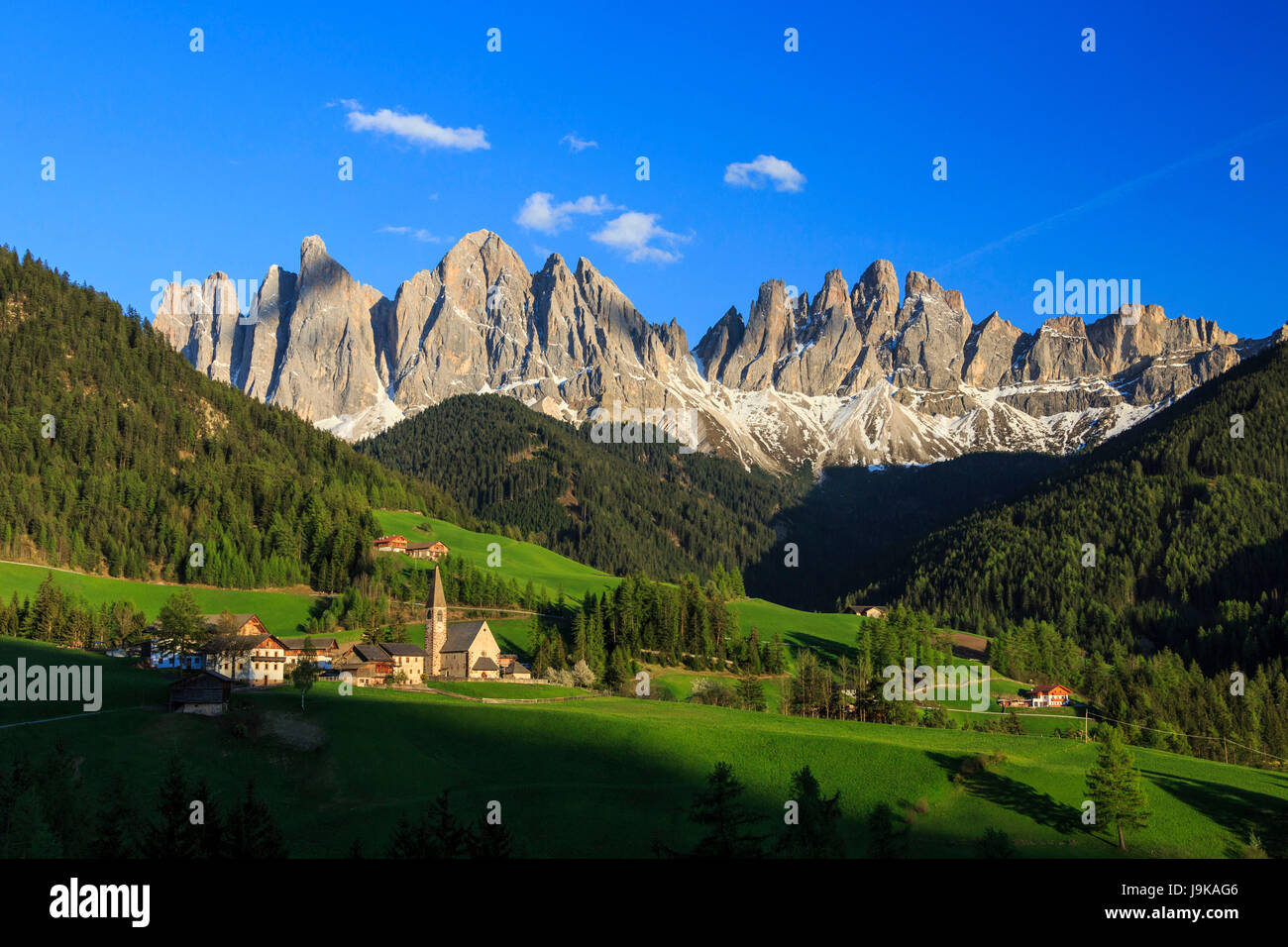 The village of St. Magdalene surrounded by green meadows at the foot of ...
