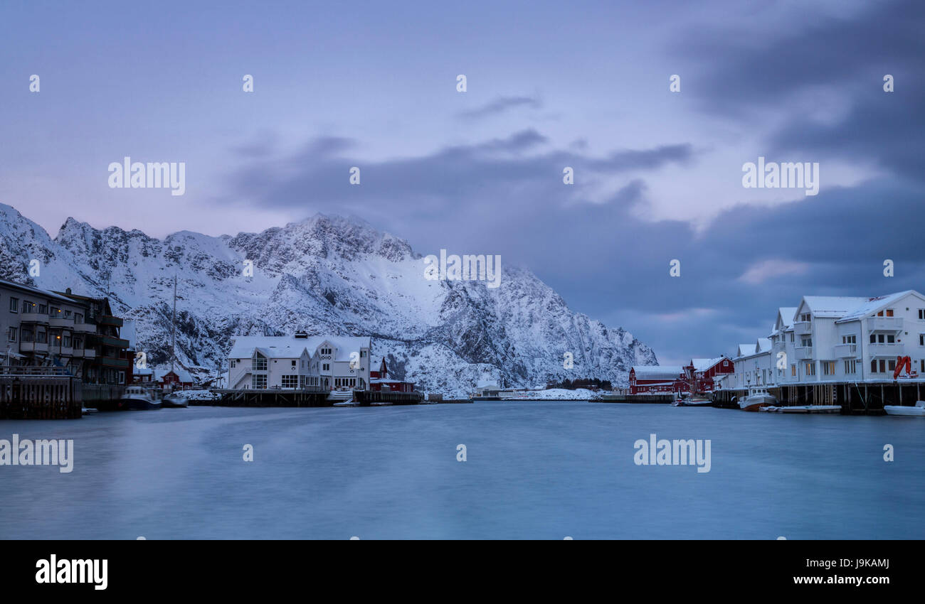 The icy sea and snow capped mountains frame the fishing village of ...
