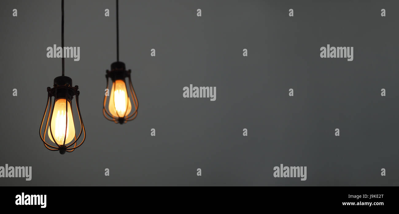 Yellow illuminated hanging light bulbs on plain background with free ...