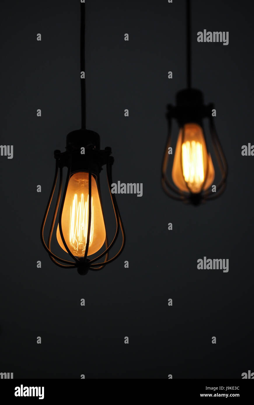 Yellow illuminated hanging light bulbs on plain background with text ...