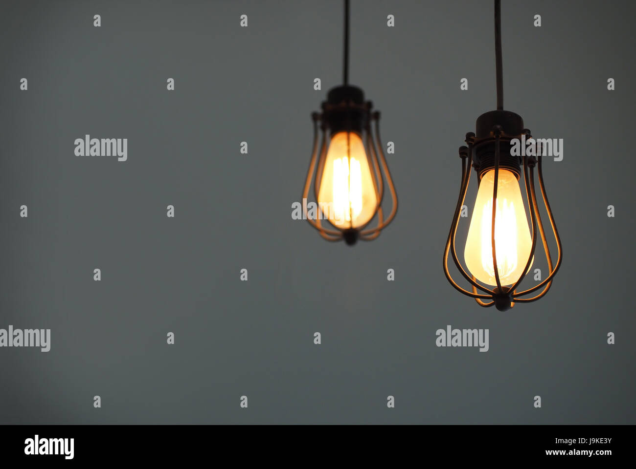 Yellow illuminated hanging light bulbs on plain background with text ...