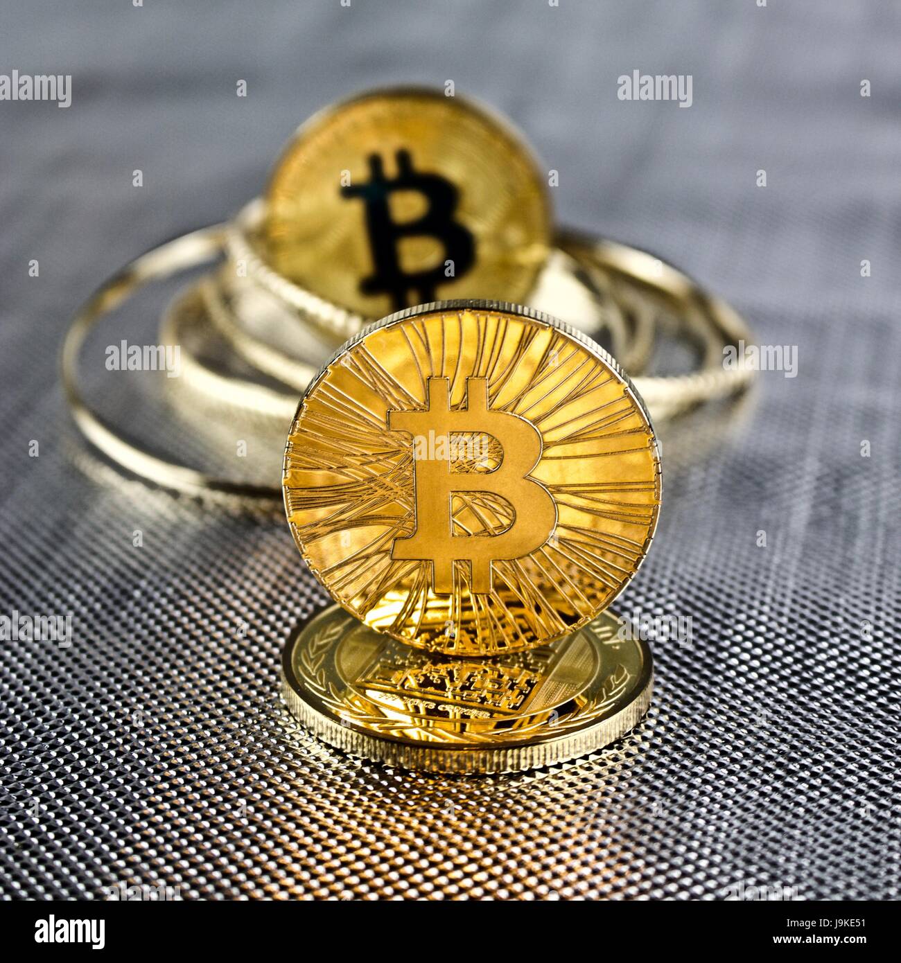 Digital currency physical gold bitcoin coins. Silver background concept ...