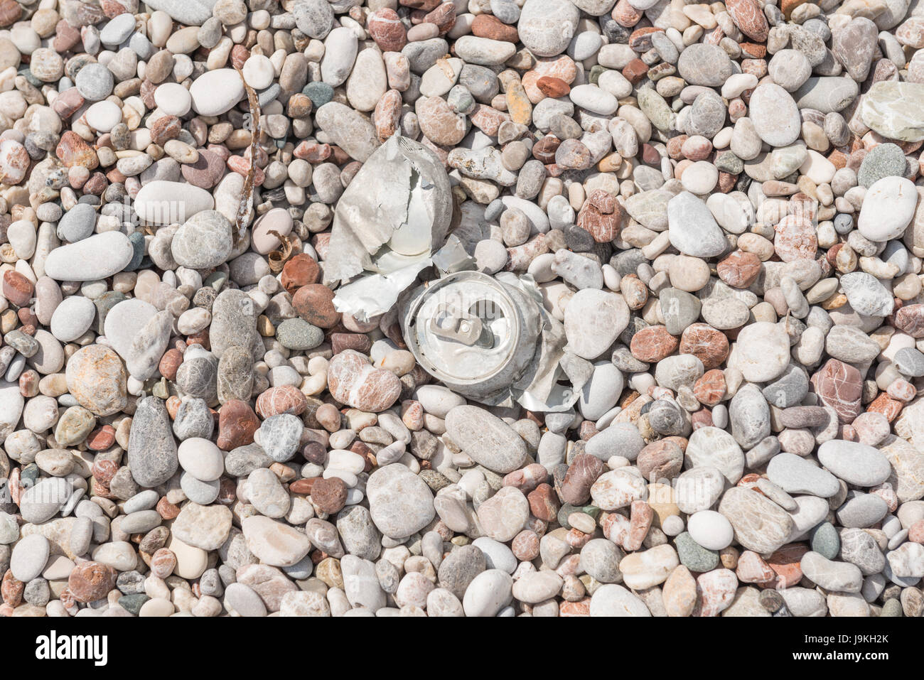 Pollution on beach stones and pebbles Stock Photo - Alamy
