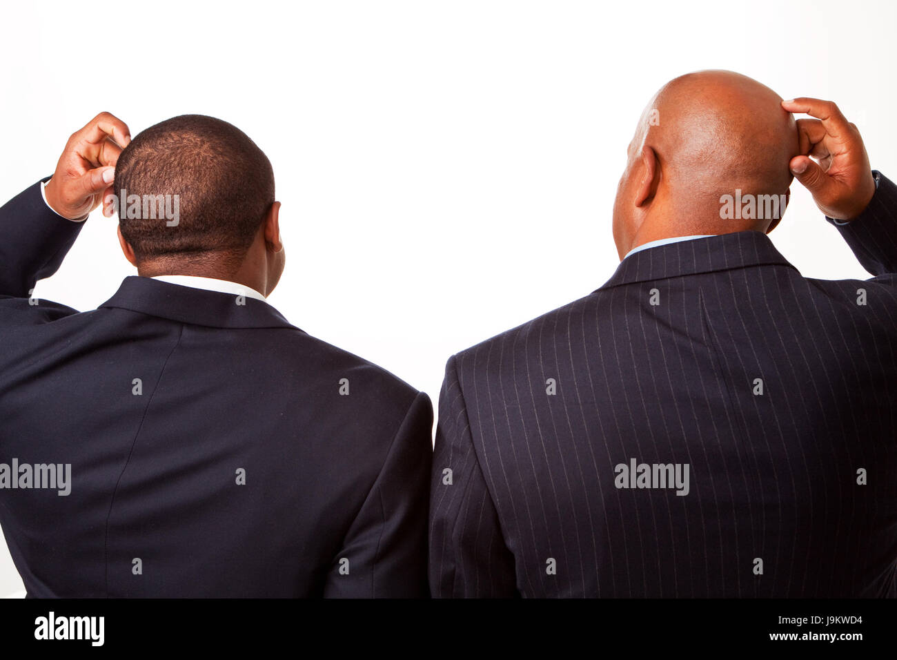 Confused Businessmen scratching their head Stock Photo - Alamy