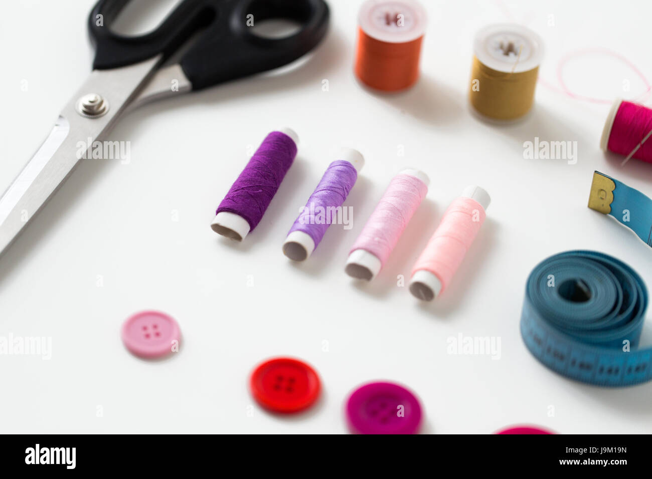 scissors, sewing buttons, threads and tape measure Stock Photo - Alamy
