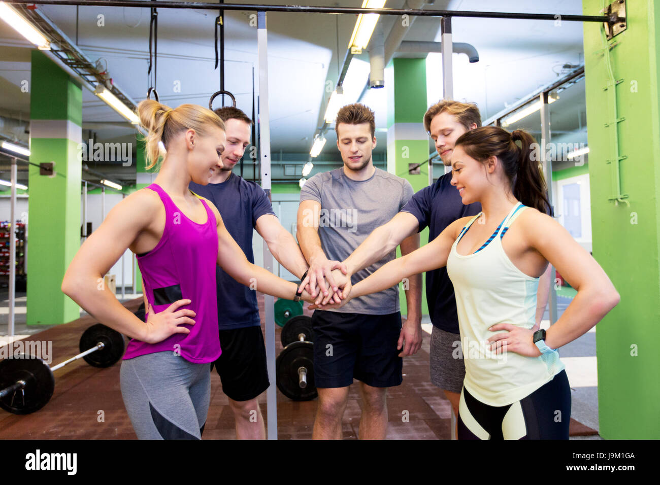 group of friends holding hands together in gym Stock Photo - Alamy