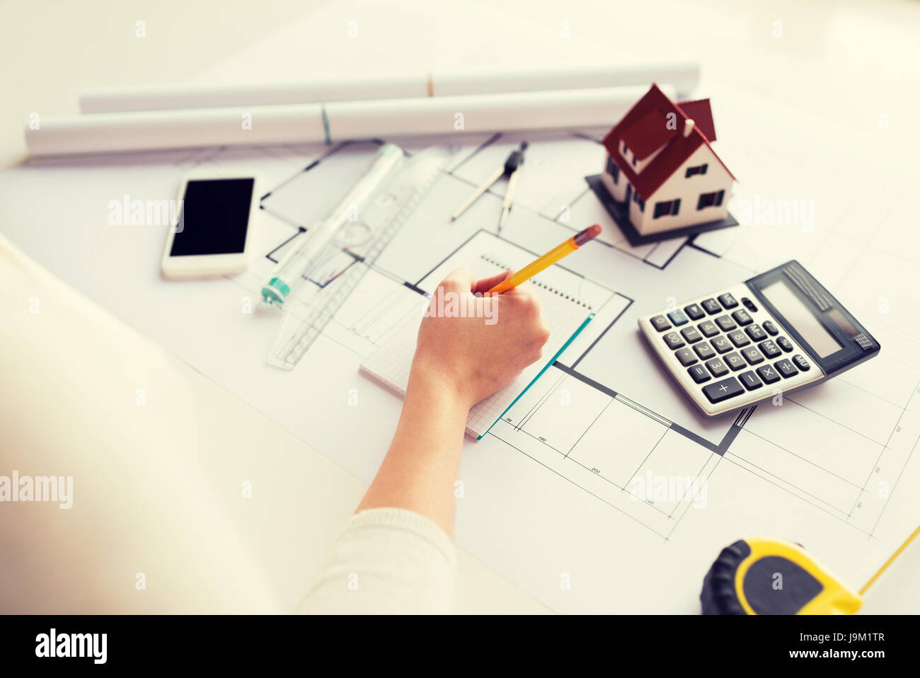 close up of hand on blueprint writing to notebook Stock Photo - Alamy