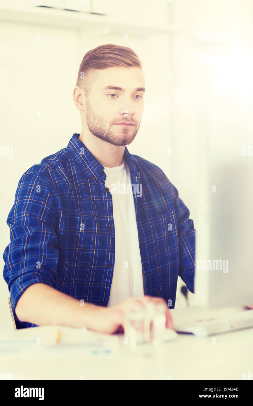 creative man or student with computer at office Stock Photo - Alamy