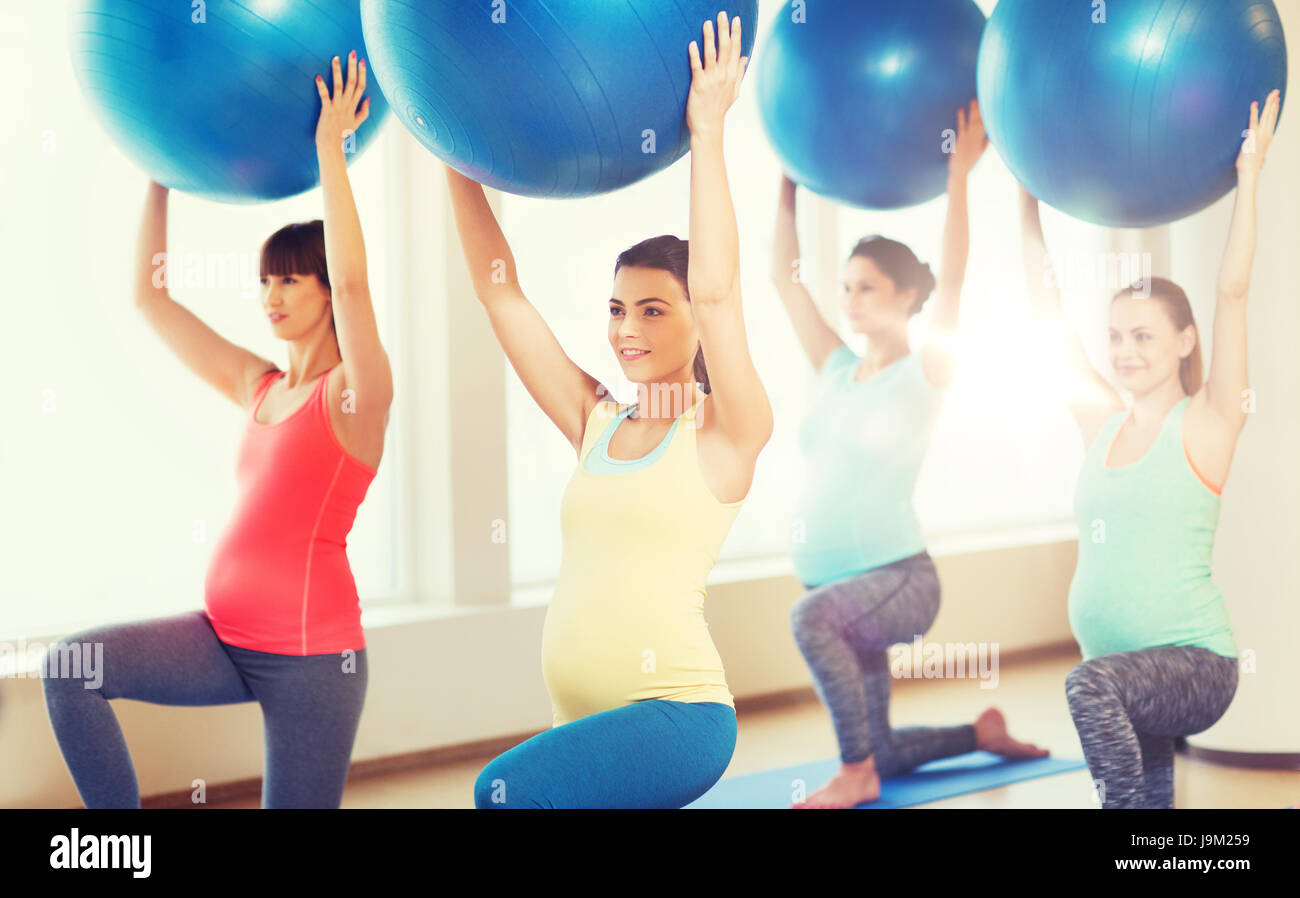 happy pregnant women exercising with ball in gym Stock Photo - Alamy