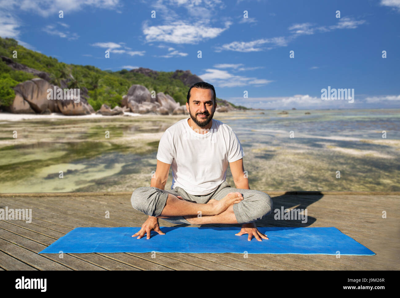 man making yoga in scale pose outdoors Stock Photo - Alamy