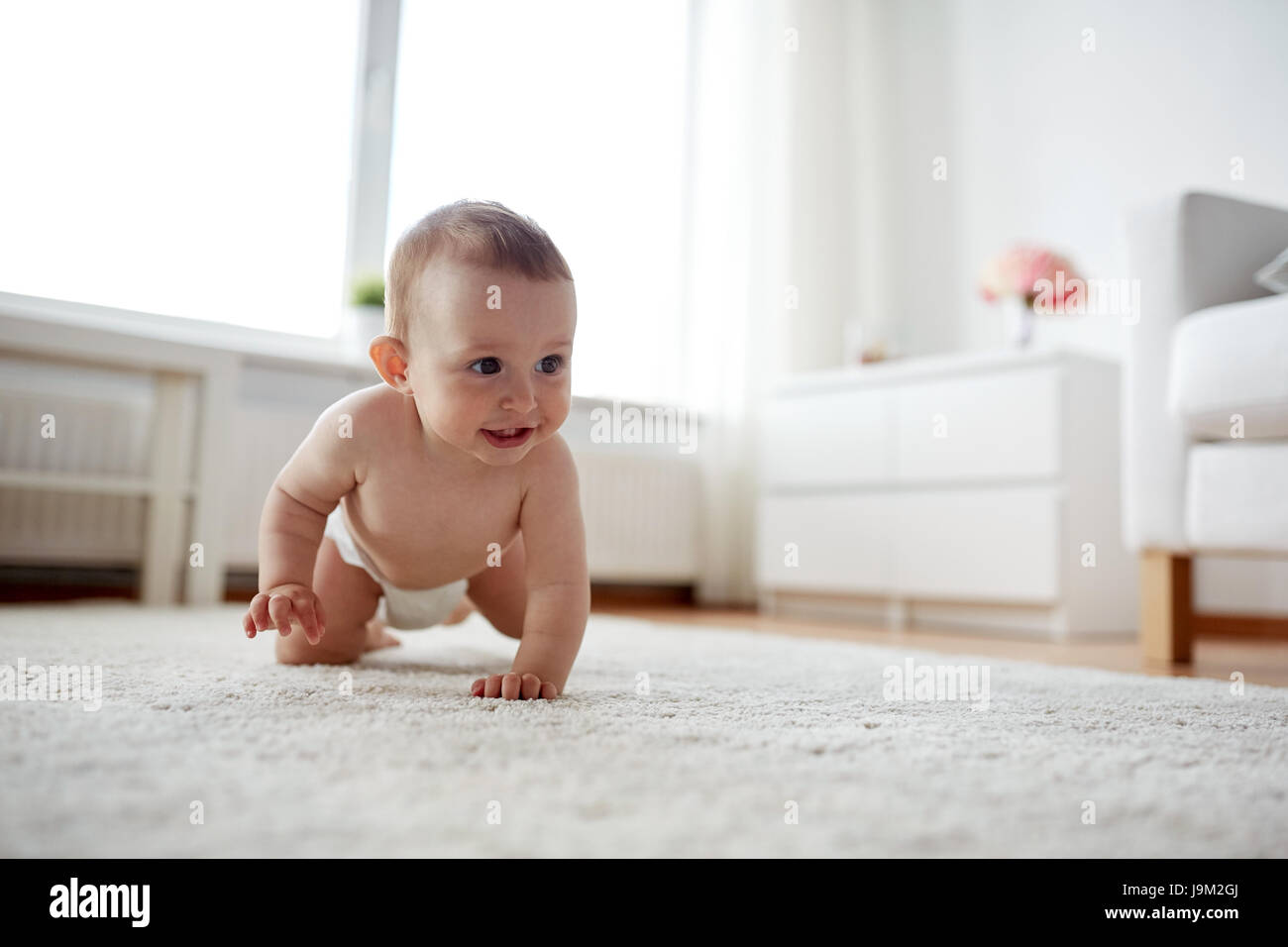 little baby in diaper crawling on floor at home Stock Photo - Alamy