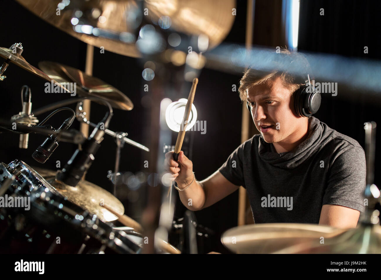 male musician playing drums and cymbals at concert Stock Photo - Alamy