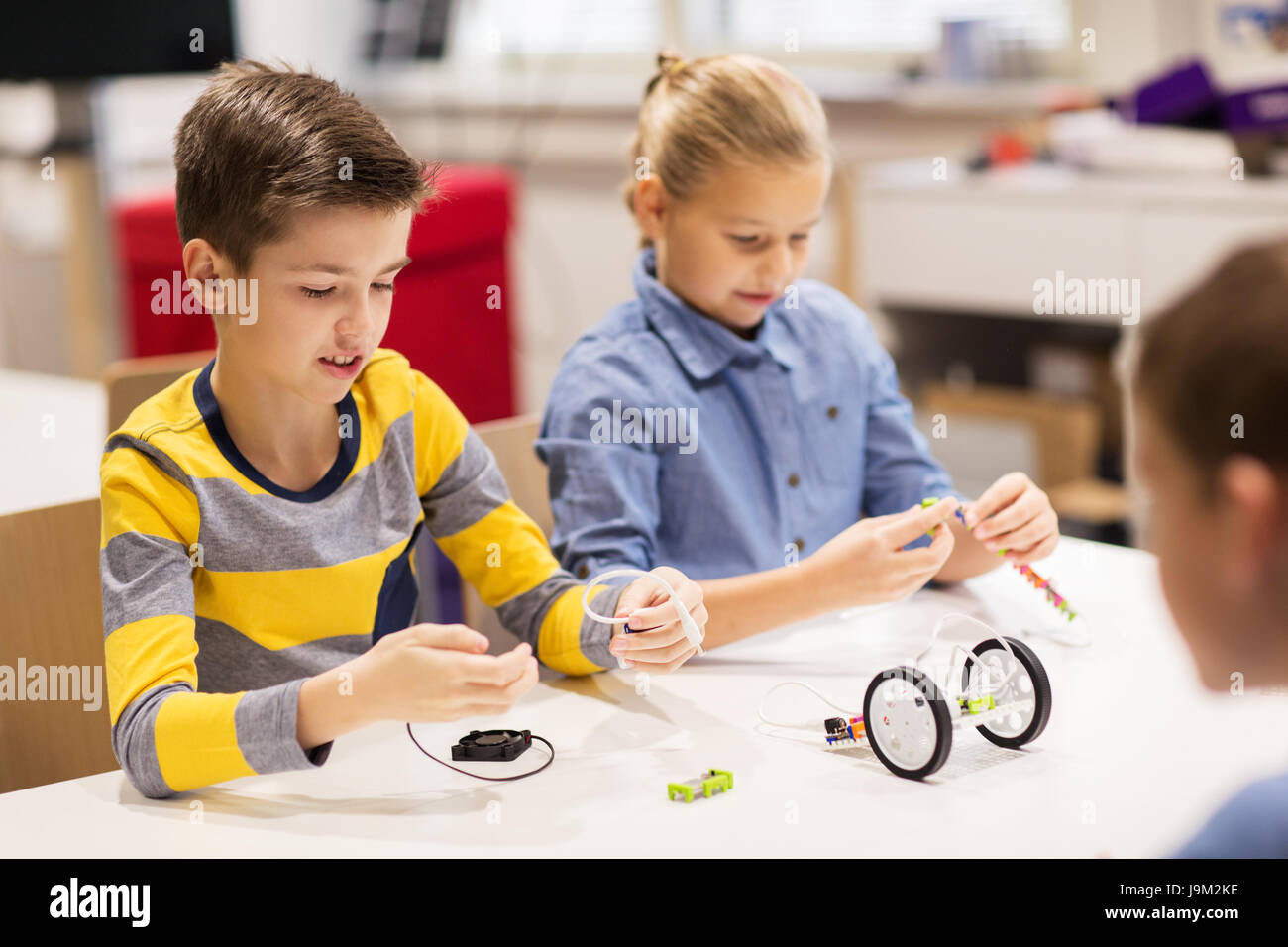 happy children building robots at robotics school Stock Photo - Alamy